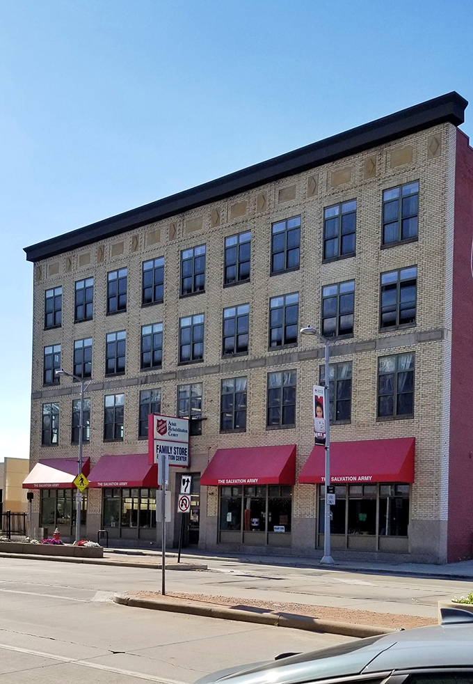 That historic façade houses modern bargains! The Salvation Army's multi-story thrift paradise stands ready to outfit homes and wardrobes on any budget.
