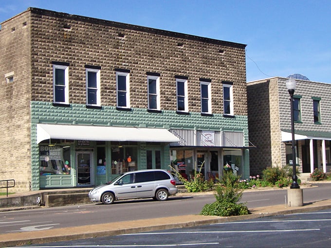Faded signs and modest storefronts line the street, but the real headline here is the mountain view.