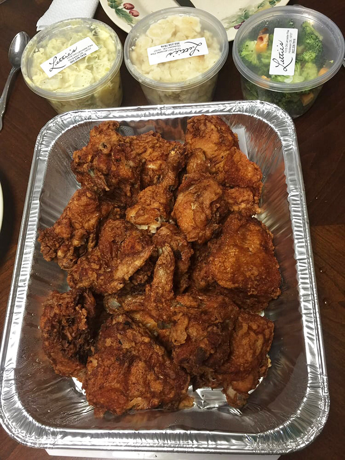 That aluminum tray holds enough fried chicken to feed a family, though sharing might become psychologically difficult after your first taste.