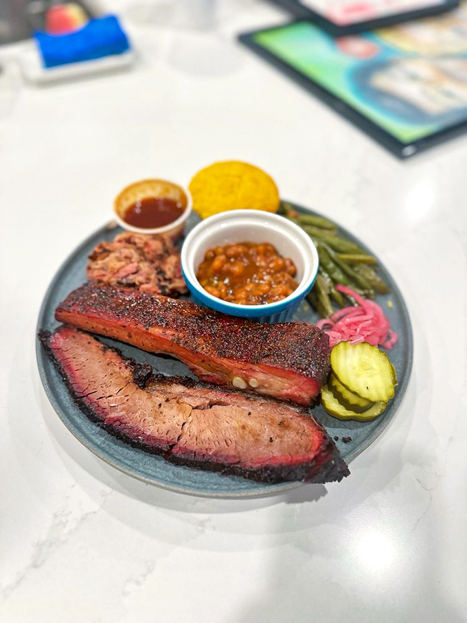 A plate that proves barbecue is the great equalizer. Brisket, ribs, and sides living in perfect harmony&mdash;like a delicious United Nations of flavor.