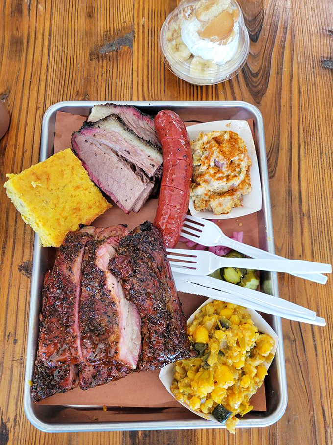 The Texas Trinity in all its glory: brisket with that perfect smoke ring, sausage with snap, and ribs that make you forget your table manners.