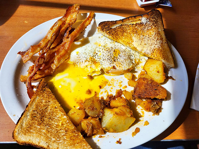 The breakfast trinity &ndash; perfectly runny eggs, golden toast, and bacon that's found that magical place between crispy and chewy.