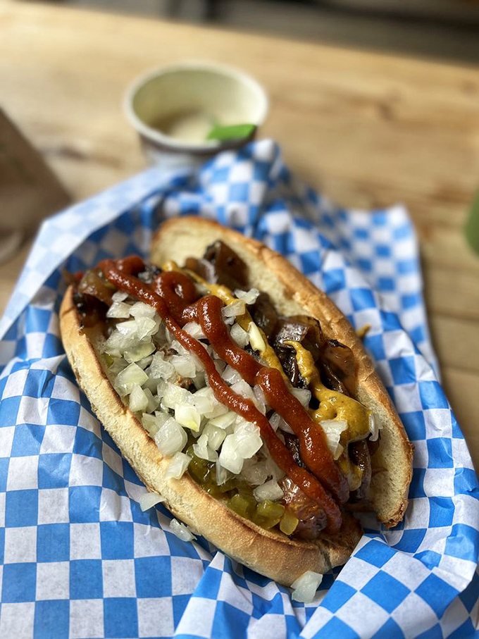 A sausage masterpiece with the works&mdash;where every bite delivers a perfect balance of snap, tang, and savory satisfaction. No ketchup needed here. 