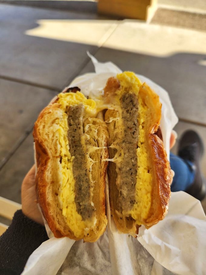 Breakfast sandwich architecture at its finest &ndash; layers of egg, meat, and cheese creating the savory yin to the cinnamon roll's sweet yang.