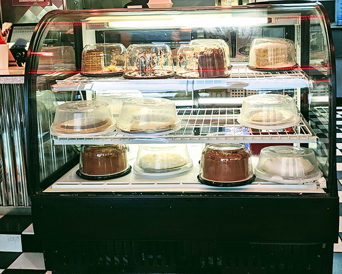 The dessert case: where willpower goes to negotiate its surrender. Each cake and pie patiently waits its turn to change someone's life.