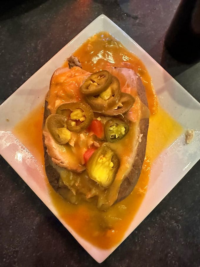 Jalapeños arranged like alien eyes atop this loaded baked potato. The sauce looks suspiciously like what powers their interstellar engines.