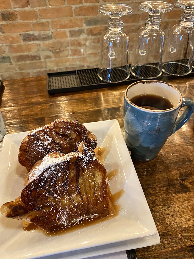 French toast that looks like it was dipped in happiness, dusted with powdered sugar, and served with locally roasted coffee.