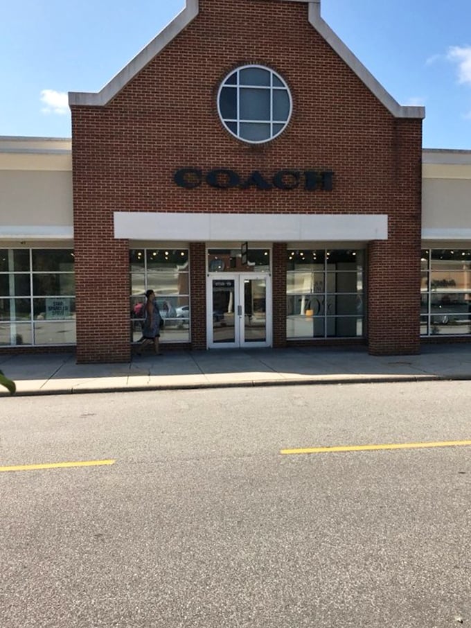 Coach's distinctive storefront, complete with that signature round window, houses leather dreams at prices that won't cause nightmares.