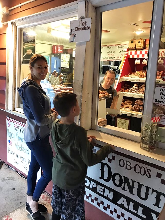 Night before Christmas vibes as hopeful customers press against the glass. The anticipation in this line could power a small city.