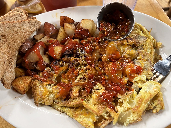 This isn't just an omelet; it's a morning masterpiece. Melted cheese cascades over eggs while toast stands by, ready for the action.