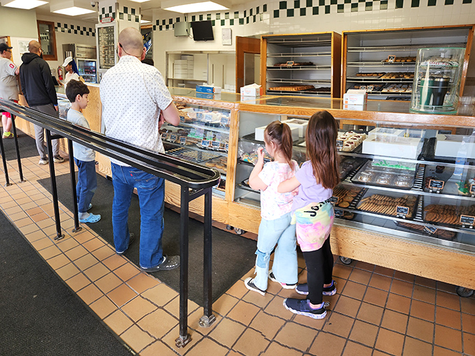 The anticipation on these young customers' faces says it all. Childhood memories in the making, one donut at a time.