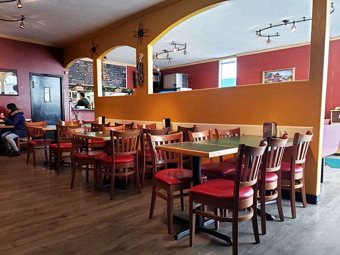 The warm yellow and red tones of the dining area create an atmosphere that says, "Stay awhile, there's no rush, and yes, order dessert."