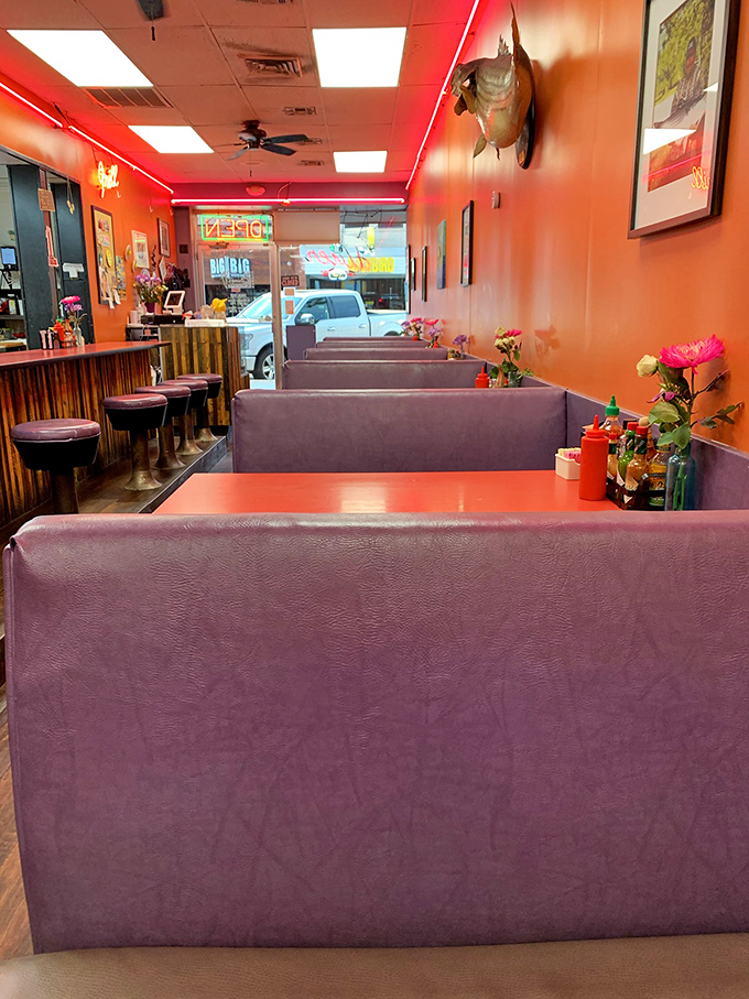 Purple booths and orange walls create a color scheme that shouldn't work but somehow feels like the exact right place to cure what ails you.