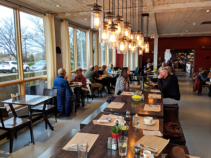 The dining room's pendant lights cast a warm glow over wooden tables where strangers become friends united by the universal language of "mmmmm."