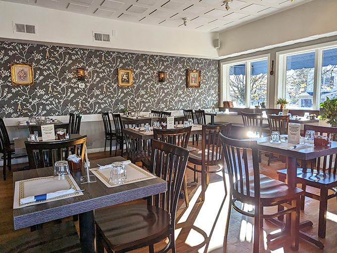 The elegant wallpaper and thoughtful lighting create a dining room that feels both sophisticated and completely unpretentious.