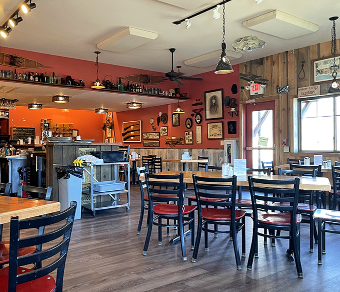 Rustic charm meets breakfast efficiency in this dining space. The orange walls radiate warmth like the feeling you get when someone says "more bacon?"