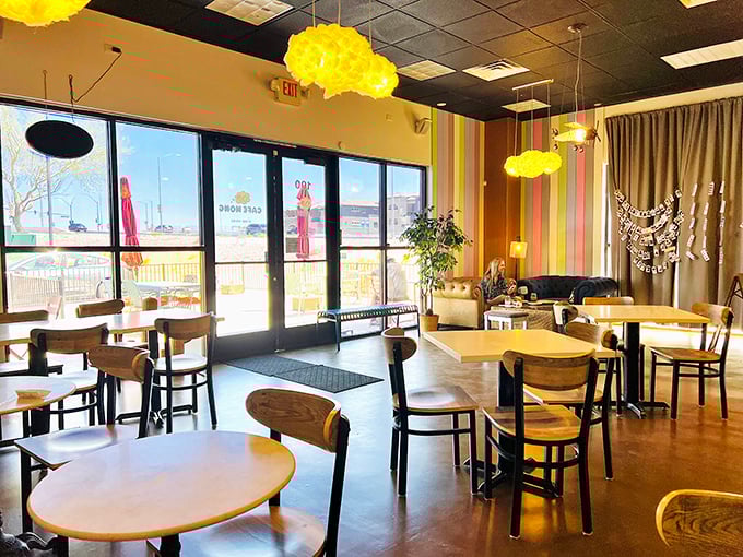 Sunshine streams through floor-to-ceiling windows while cloud-shaped lights hover overhead&mdash;breakfast with a side of good vibes.