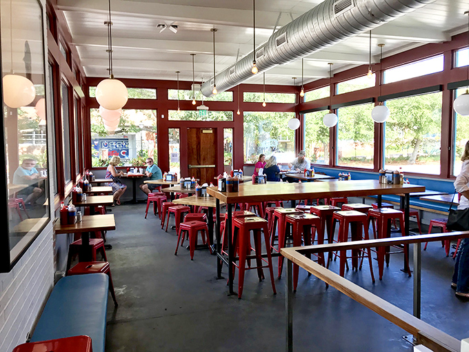 Industrial meets homey in this light-filled dining space. The exposed ductwork whispers, "We're serious about ventilation and barbecue."