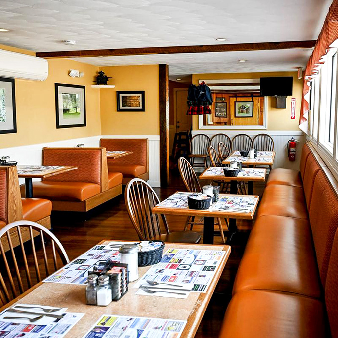 Orange booth seating and Windsor chairs create that classic diner tableau where life-changing conversations happen over bottomless coffee refills.