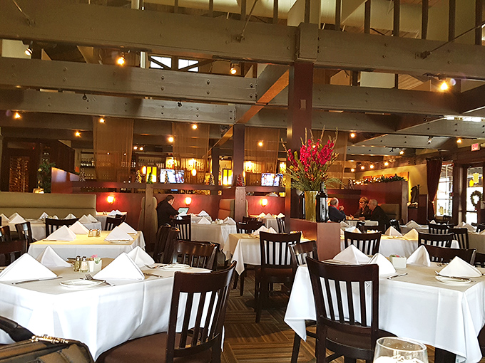 White tablecloths, warm lighting, and wooden beams create that rare atmosphere where you feel both pampered and completely at home.