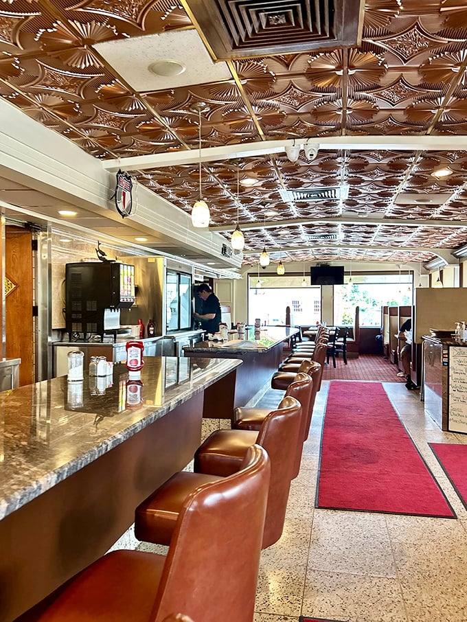 Copper ceiling tiles gleam above leather counter stools, where strangers become friends over pie and coffee at this classic Jersey diner.