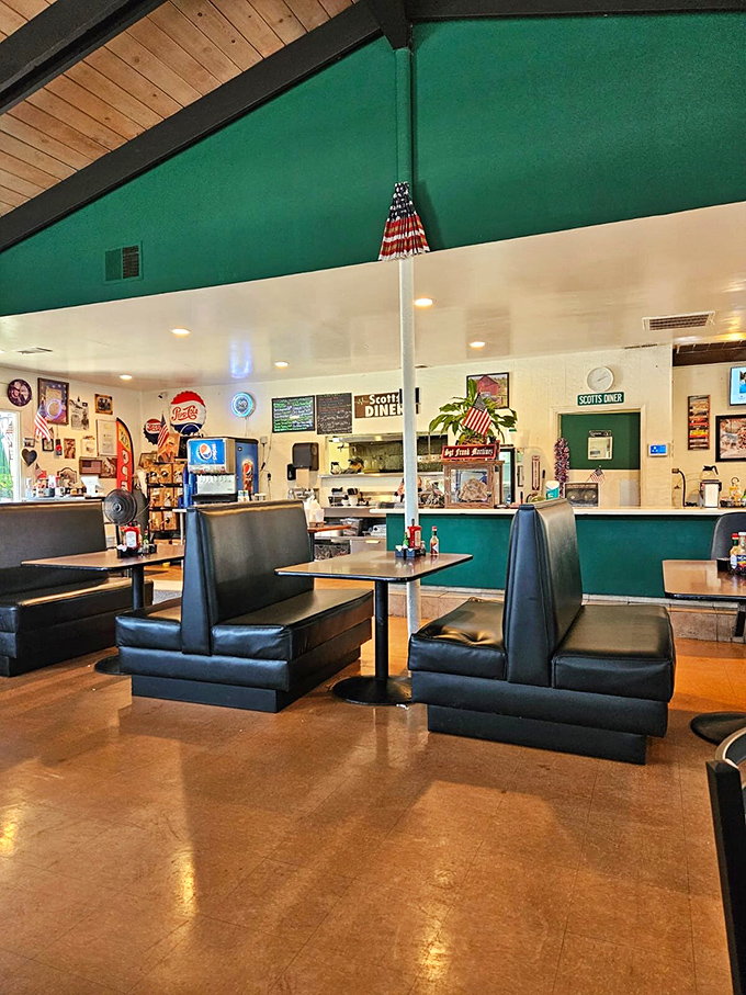 Classic black booths against turquoise walls create that quintessential American diner experience where every seat feels like the best in the house.