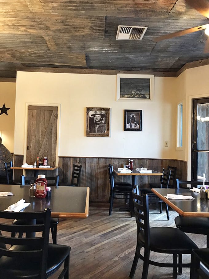 Western movie stars watch over diners from wooden-framed portraits, silently approving your decision to order the bigger cut.