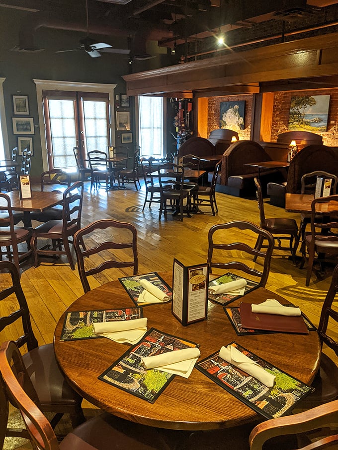 Wooden chairs, polished tables, and warm lighting create the perfect stage for culinary drama. Every table tells a different delicious story.