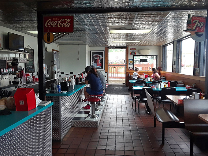 The diner's rhythm section: counter service, booths, and the symphony of breakfast conversations playing against the backdrop of sizzling grills.