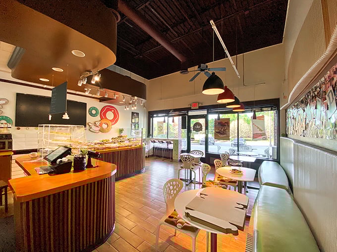 The dining area offers front-row seats to the donut show, where the ceiling's exposed beams remind you this is serious culinary business disguised as casual fun.