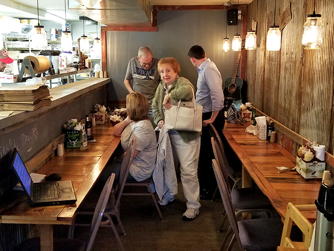 Mason jar lights illuminate wooden tables where BBQ dreams come true. The dining area feels like the best kind of family reunion—one centered around smoked meat.