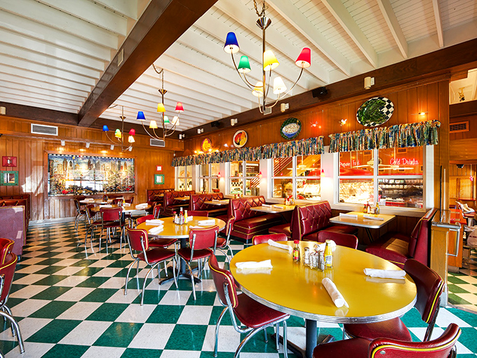 That classic checkered floor says "timeless diner," while those burgundy booths have cradled generations of satisfied customers.