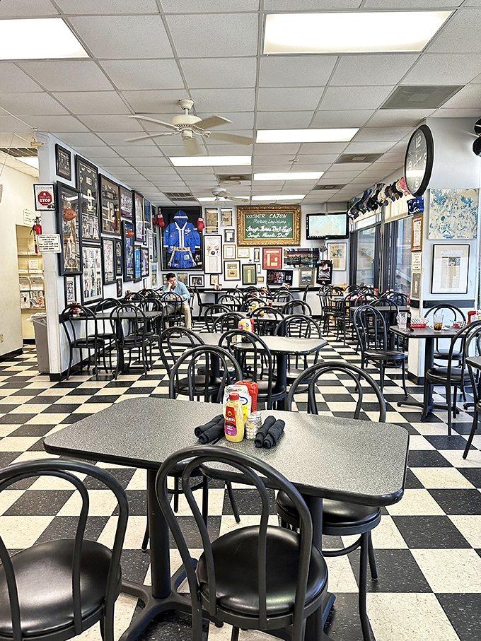 Classic bistro chairs, checkered floors, and walls filled with memories. This dining room feels like it's been hosting neighborhood gossip for generations.