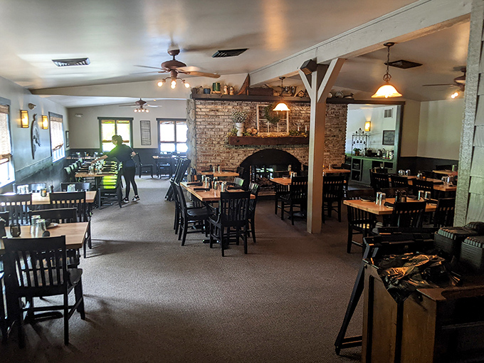 The stone fireplace centerpiece anchors this dining room like a family patriarch, warming conversations and creating the backdrop for countless celebrations.