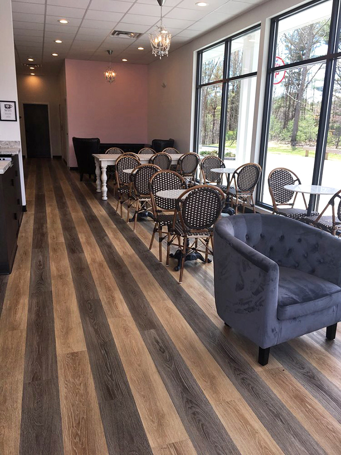 Parisian bistro meets New England charm with these black and white café chairs, pink accent walls, and crystal chandeliers.
