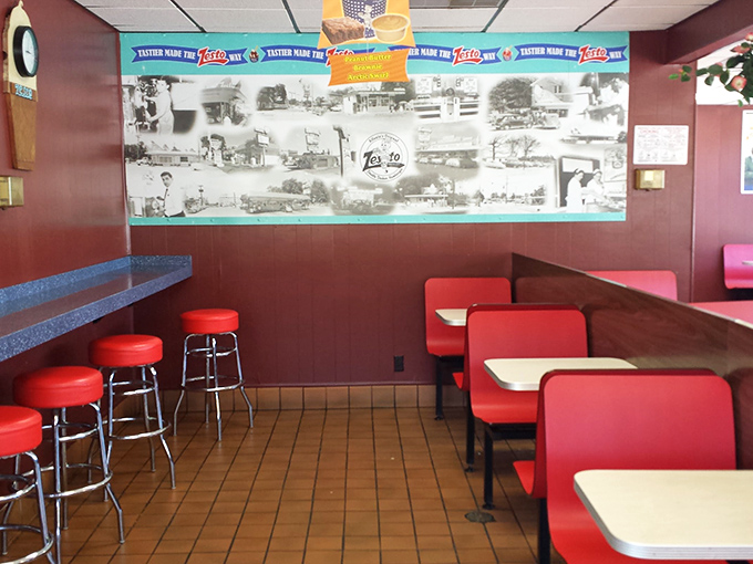 Classic diner booths in vibrant red create the perfect backdrop for comfort food conversations. Note the historic photos—visual comfort food for Atlanta natives.