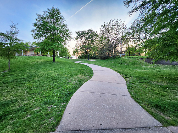 Winding paths through Dogwood Park offer peaceful strolls where conversations replace expensive therapy and sunshine is always free.