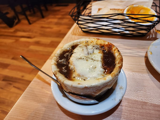 French onion soup that's worth the cheese pull photo-op – a crock of savory comfort topped with the kind of golden, bubbly crust that dreams are made of.