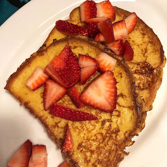 French toast that makes ordinary bread blush with embarrassment, topped with fresh strawberries that add just the right amount of tartness.