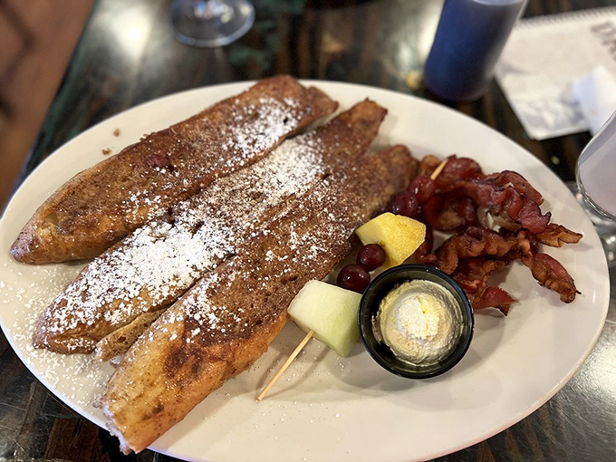French toast that would make actual French people jealous. Those bacon slices are the breakfast equivalent of finding an extra twenty in your pocket.