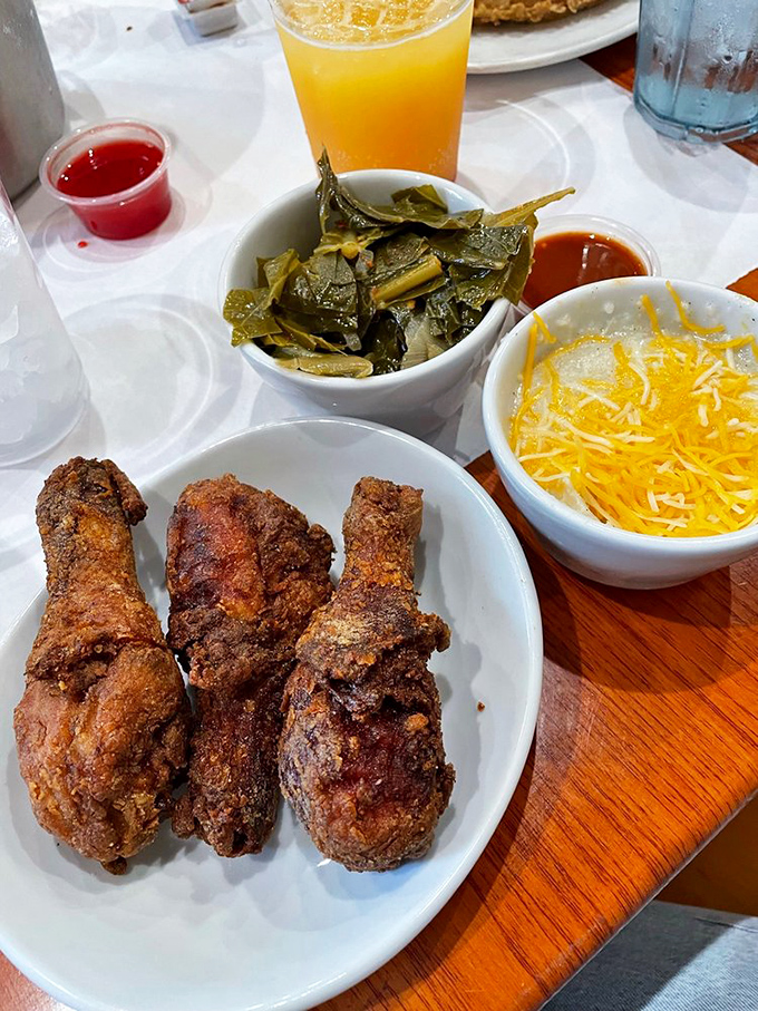 Three pieces of chicken so perfectly fried they make Colonel Sanders look like he's still in basic training, accompanied by collards and cheese grits.