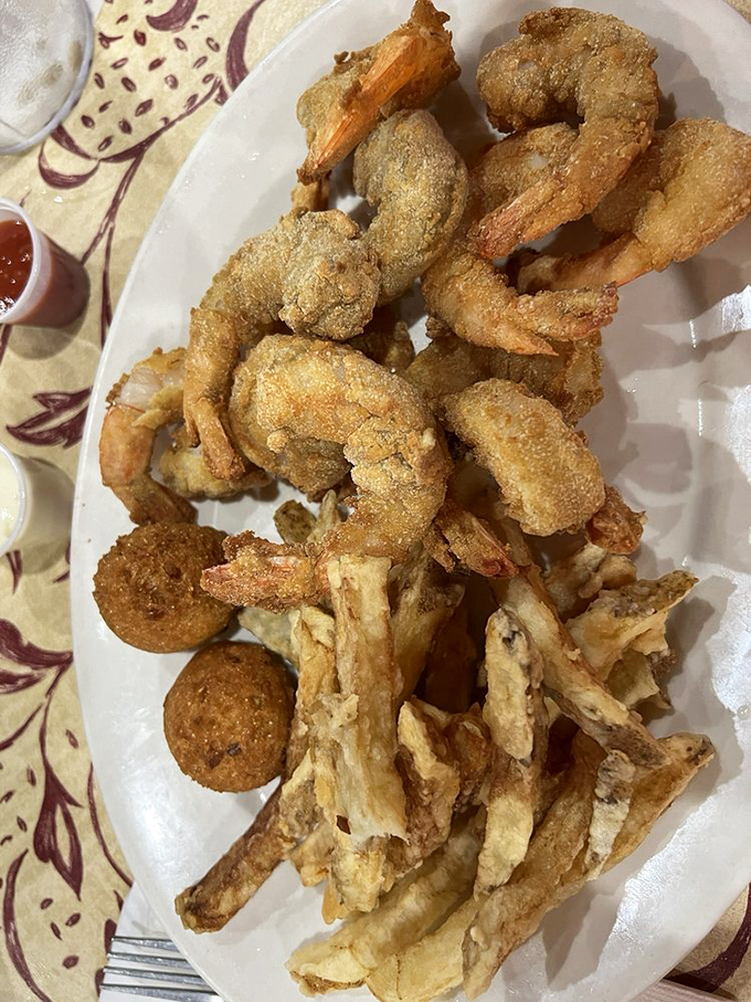 Fried shrimp that snap when you bite them, hushpuppies with that perfect cornmeal crunch, and something mysteriously delicious hiding in that dipping sauce.