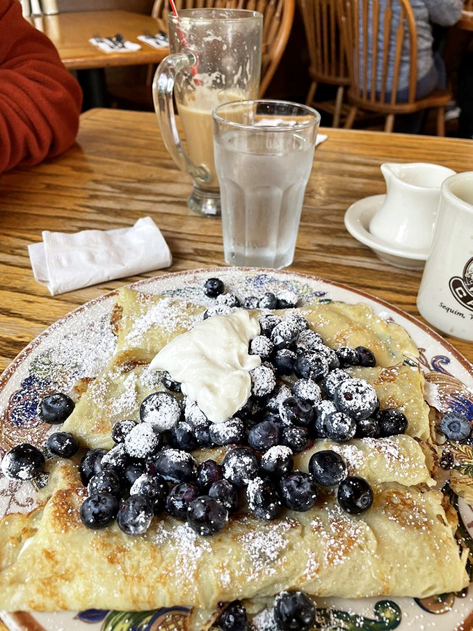 Blueberry blintzes that make you wonder why you don't eat blintzes every day. That powdered sugar snowfall and whipped cream dollop are the perfect finishing touches.