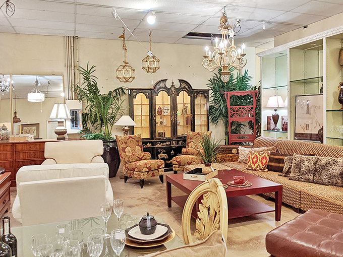 Warm woods and elegant chandeliers create an atmosphere of timeless sophistication. This living room setup is practically begging for a book club to move in.