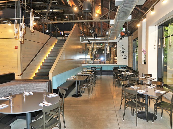 The staircase leading to the mezzanine isn't just architectural&mdash;it's a metaphor for the elevated dining experience you're about to have.