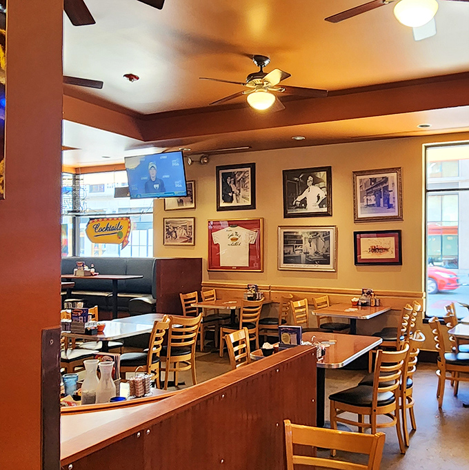 Historic photos line the walls while ceiling fans keep the atmosphere as cool as the conversation. Diner design perfected over decades.