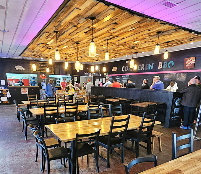 Where barbecue magic happens. The wooden ceiling, pendant lights, and chalkboard menu create an atmosphere of casual reverence for smoked meat artistry.