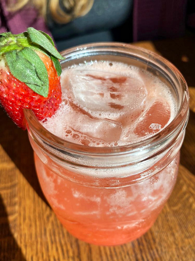 That strawberry garnish isn't just decoration – it's a promise that this cocktail contains actual fruit and not some mysterious "natural flavoring."