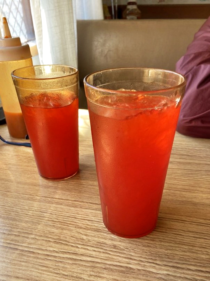 That vibrant red Kool-Aid isn't just a beverage—it's a nostalgic time machine in a glass, the perfect sweet companion to cut through rich, savory soul food.