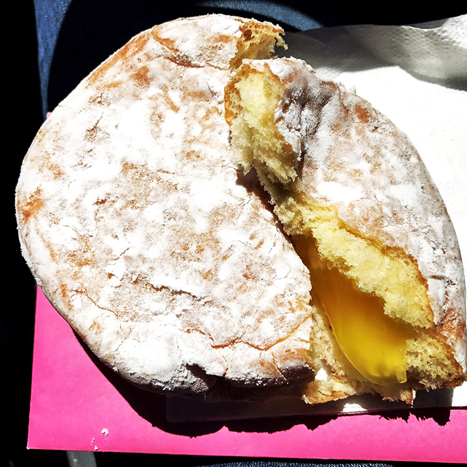 Cut into this powdered beauty and watch lemon filling escape like sunshine breaking through clouds. Breakfast or dessert? Yes.